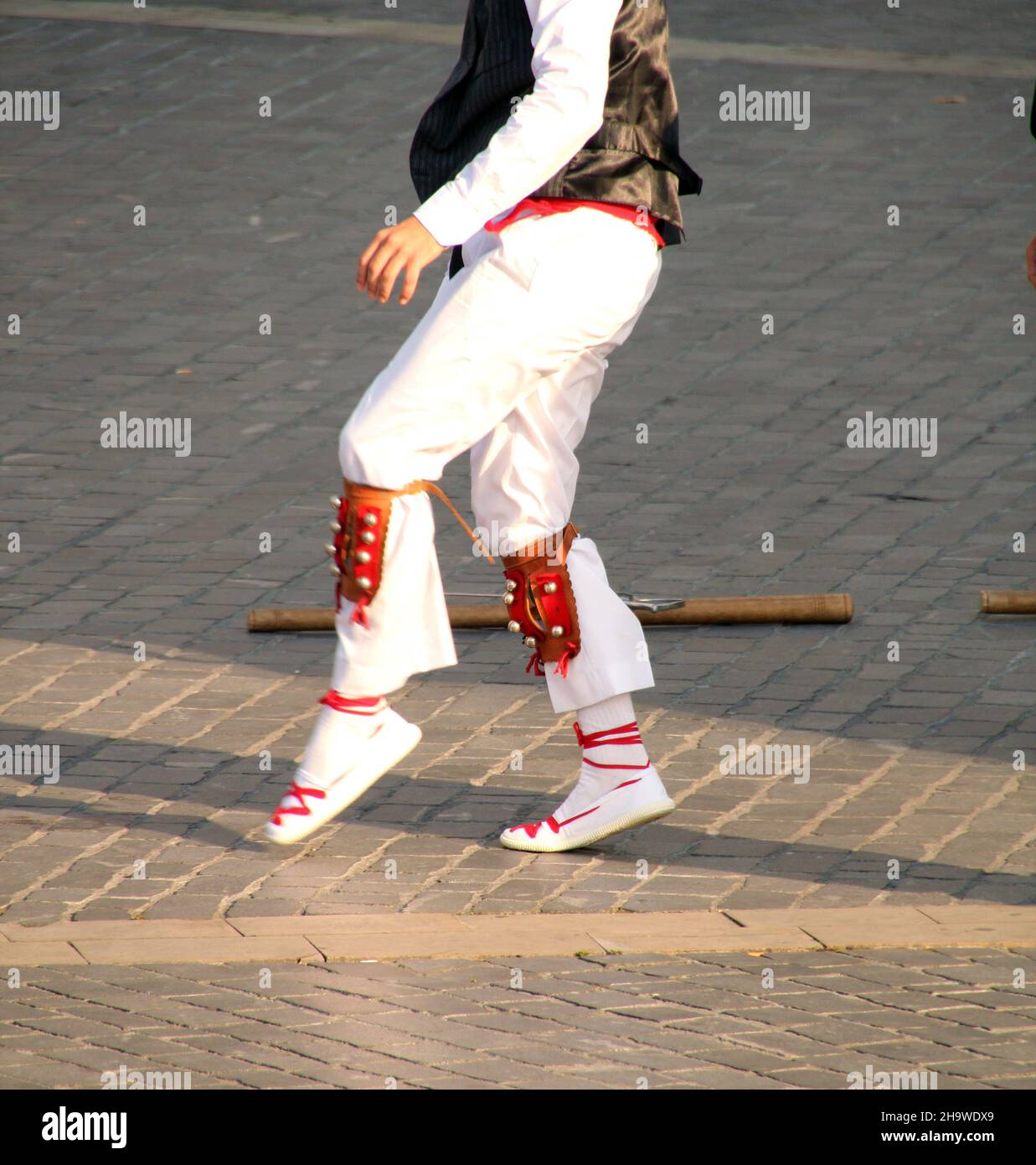 Vertical shot of a person in traditional clothing doing a folk dance in ...