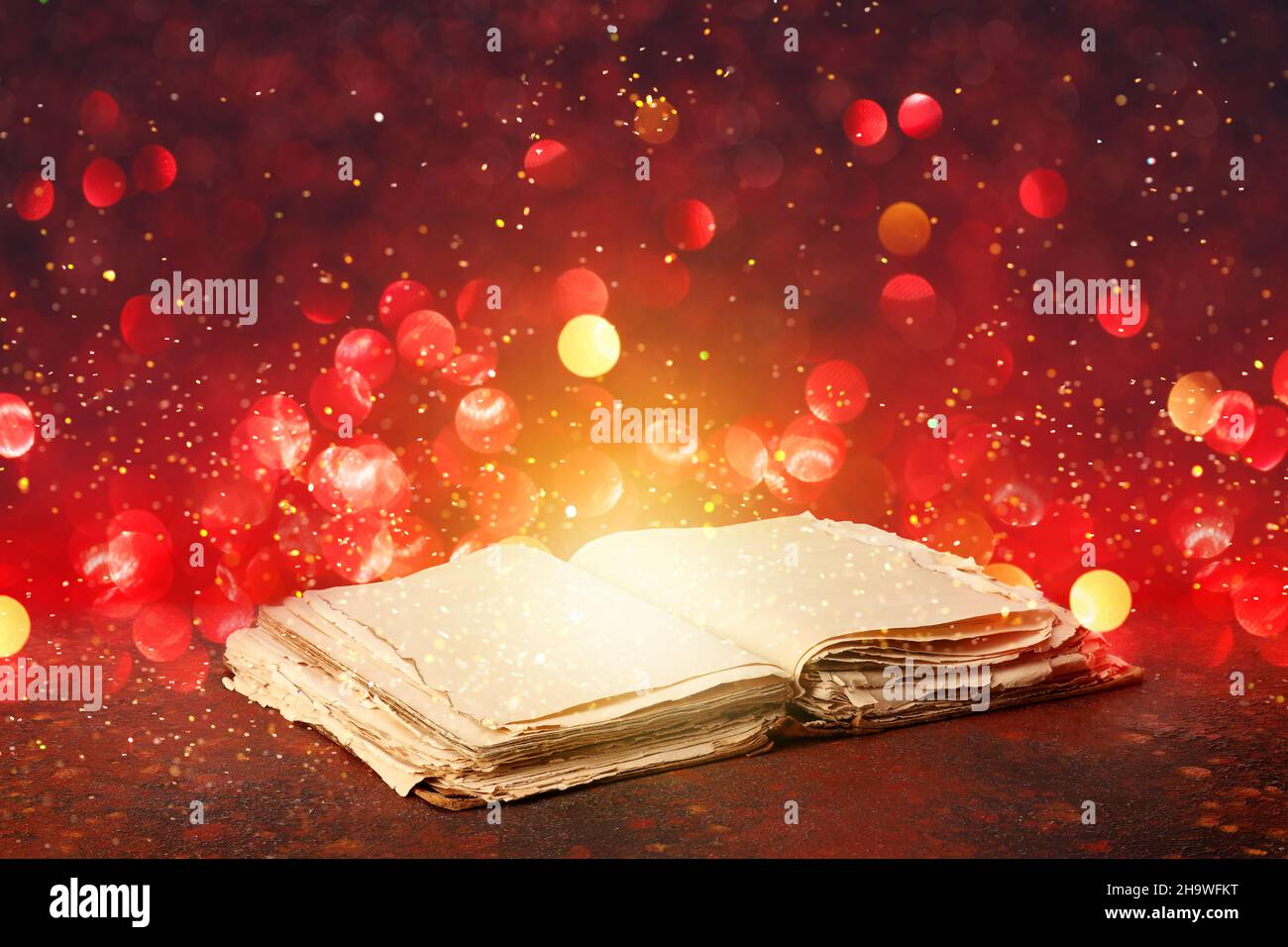 Open magic book on dark color background Stock Photo - Alamy