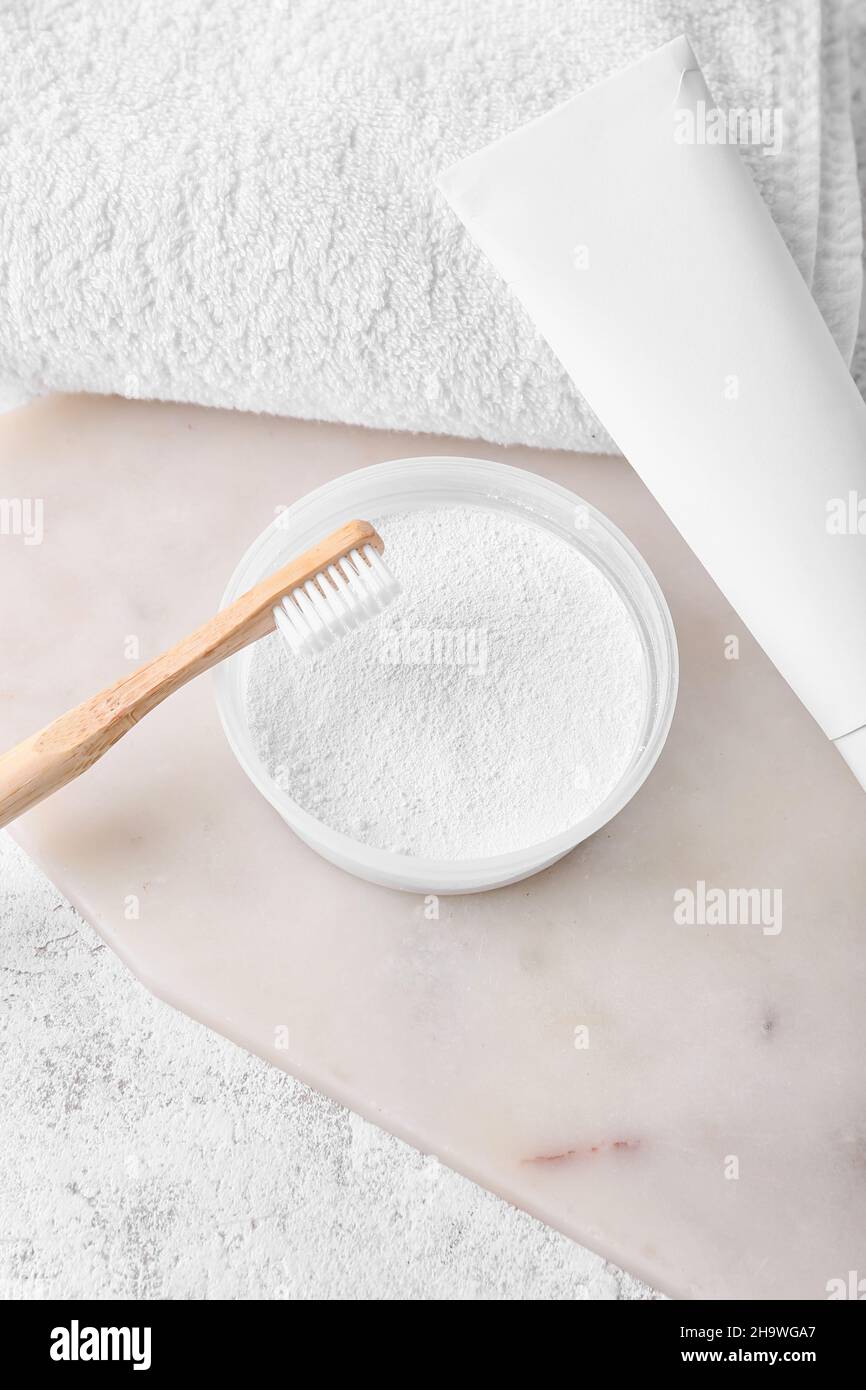 Wooden toothbrush, paste and powder on light background Stock Photo - Alamy