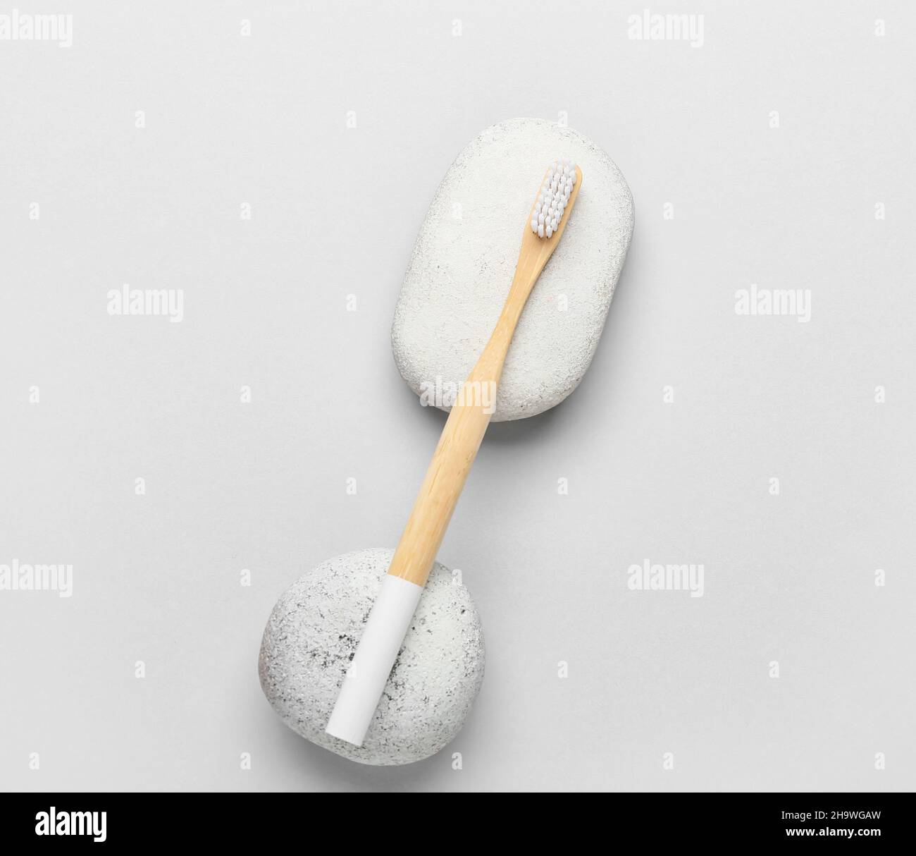 Wooden toothbrush on grey background Stock Photo - Alamy