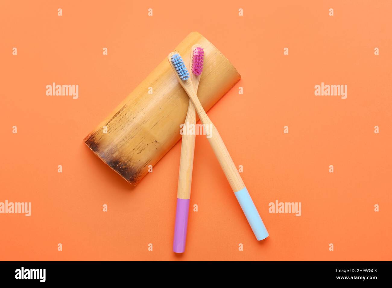 Different wooden toothbrushes on color background Stock Photo - Alamy