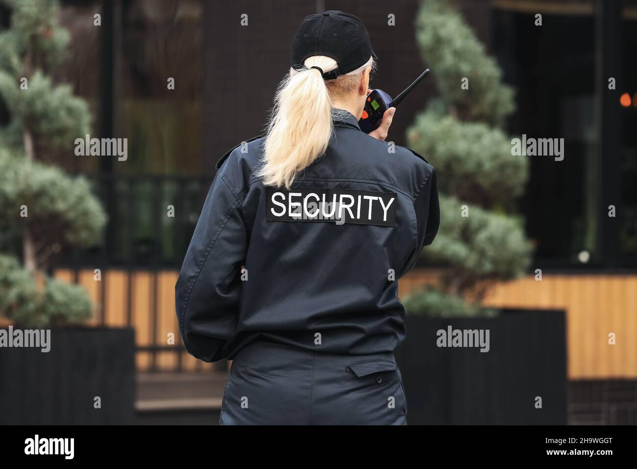 Female security guard outdoors, back view Stock Photo - Alamy