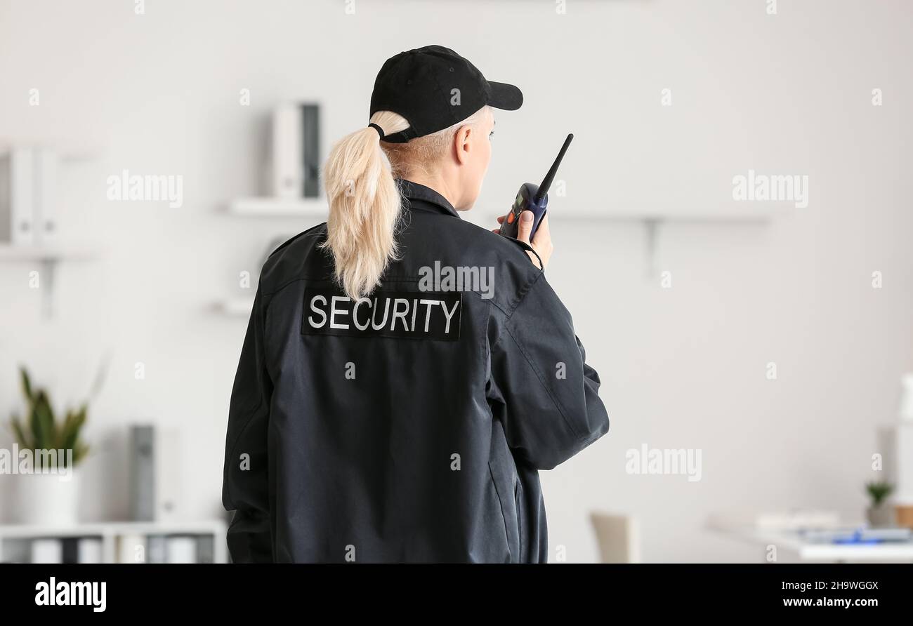 Female security guard with radio transmitter in office Stock Photo - Alamy