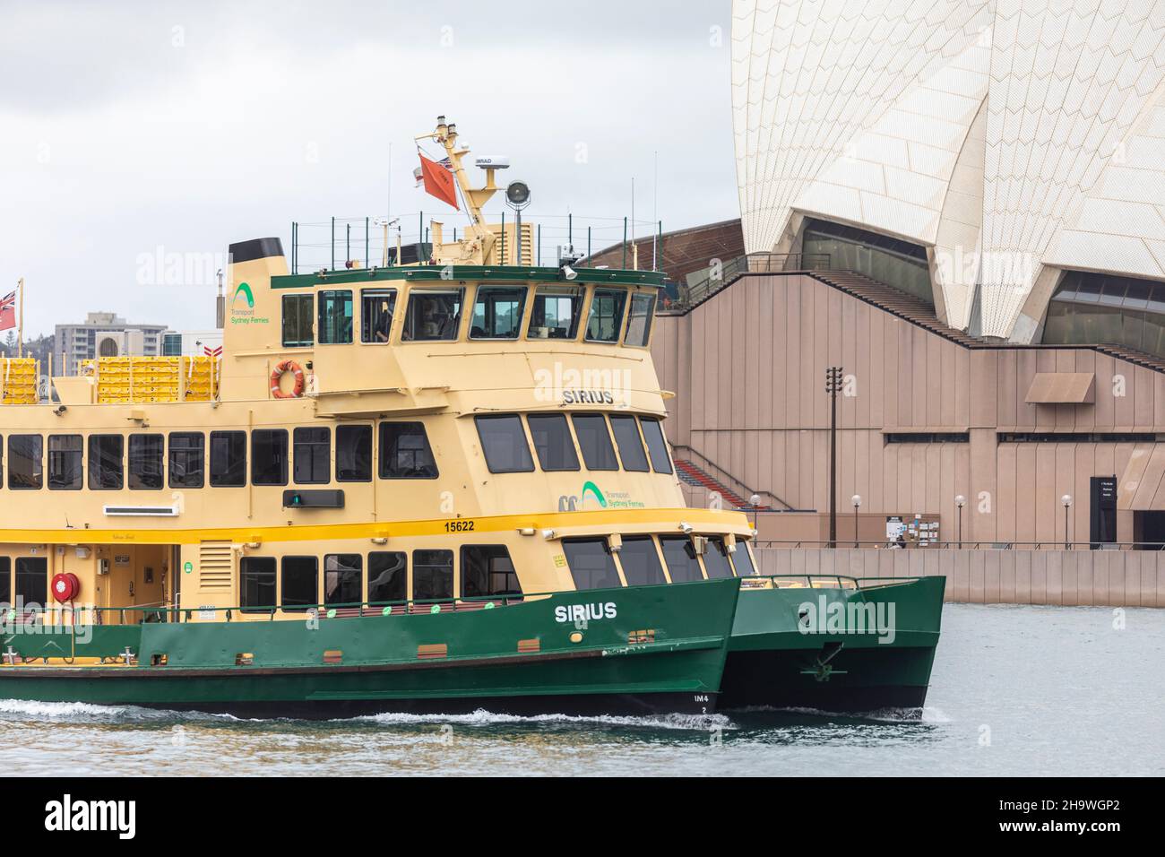 First fleet class Sydney ferry MV Sirius passes the Sydney Opera house on a gloomy summers day ...