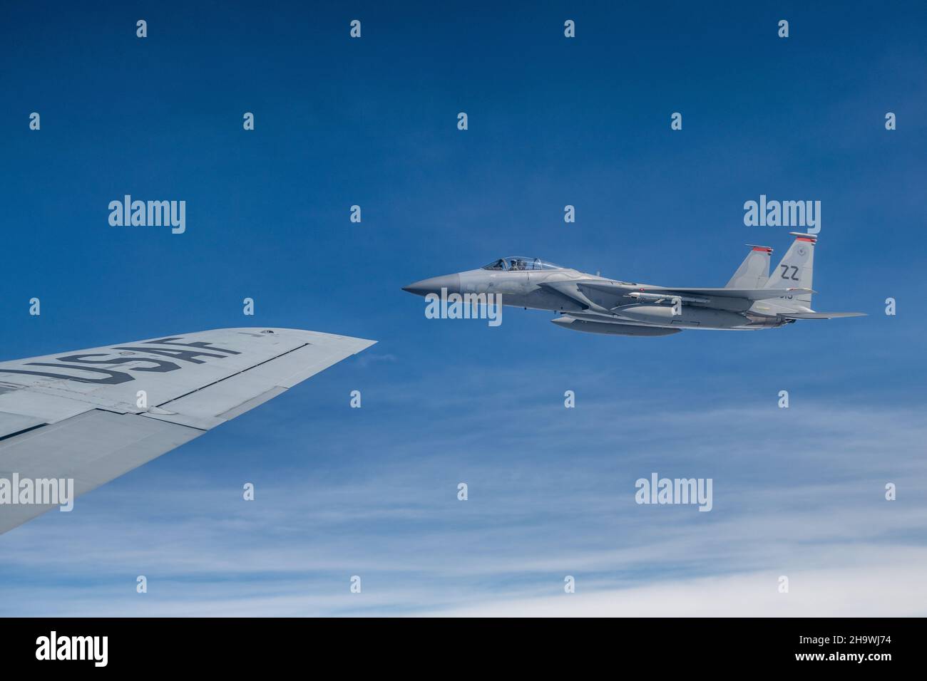 A 67th Fighter Squadron F-15C Eagle flies next to the wing of a 909th ...