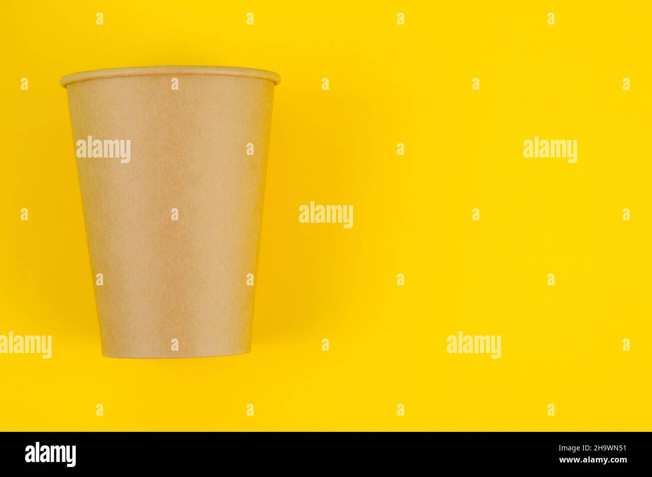 Brown paper drink glass disposable on yellow background. Eco friendly ...