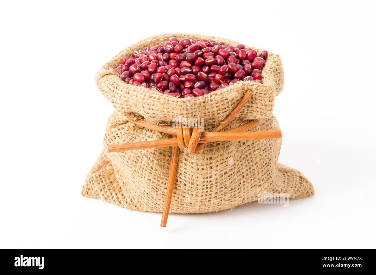 Red small Azuki beans (Adzuki or japanese red bean) in sack bag on white background Stock Photo ...