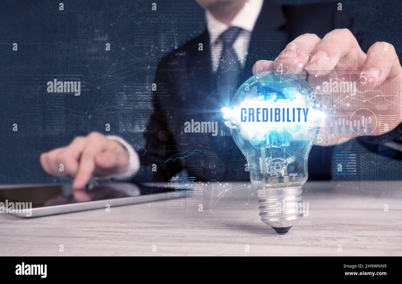 Businessman holding a light bulb, business concept Stock Photo - Alamy