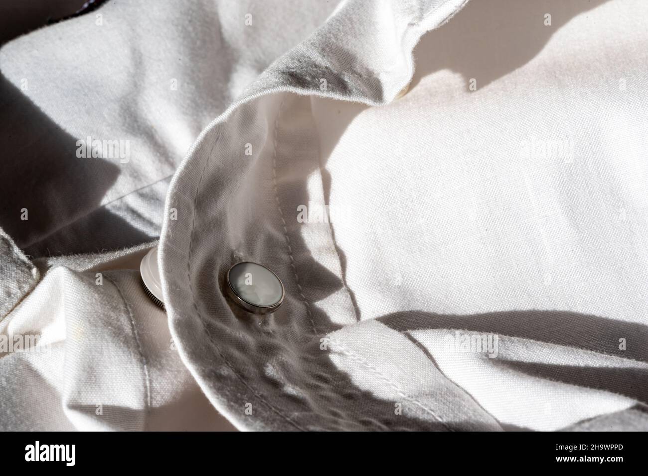 button extender shown on a white dress shirt to increase size Stock ...