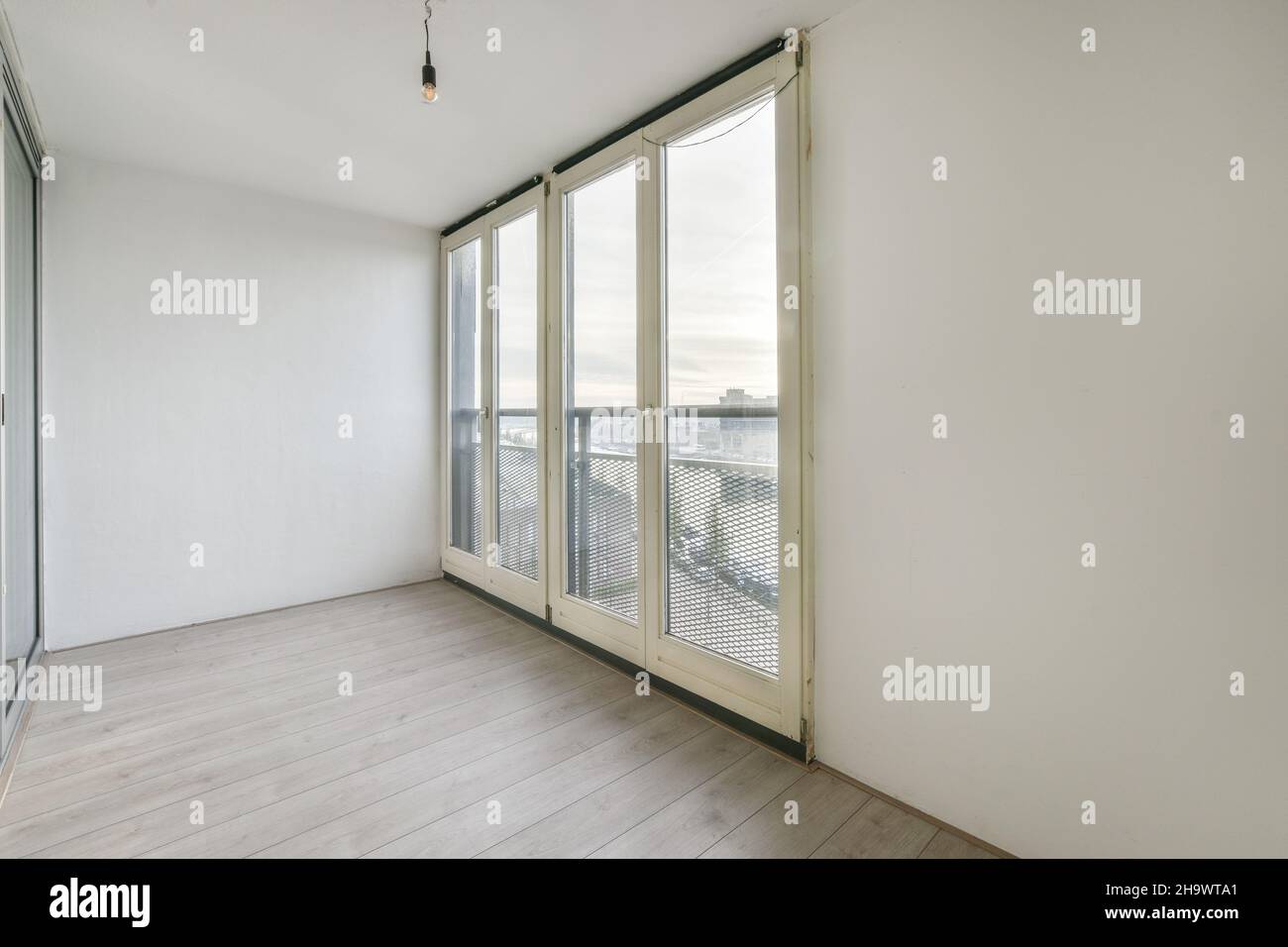 A bright room with large windows on the entire wall Stock Photo - Alamy