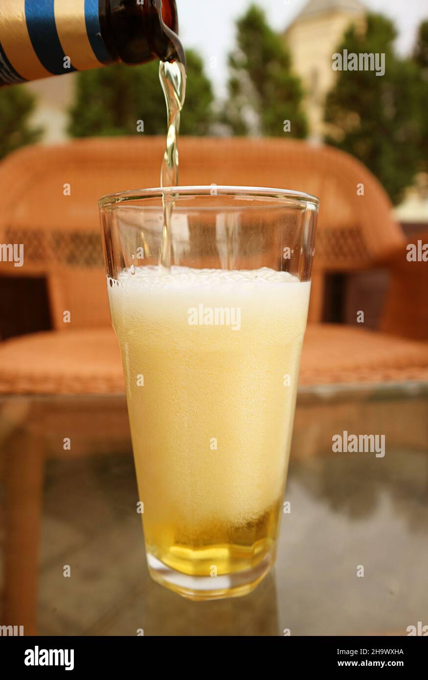 Chilled lager beer being poured into a glass Stock Photo - Alamy