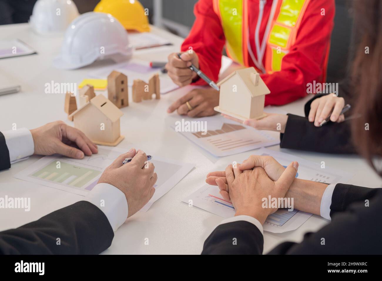 Closeup hand in teamwork business meeting for construction project ...