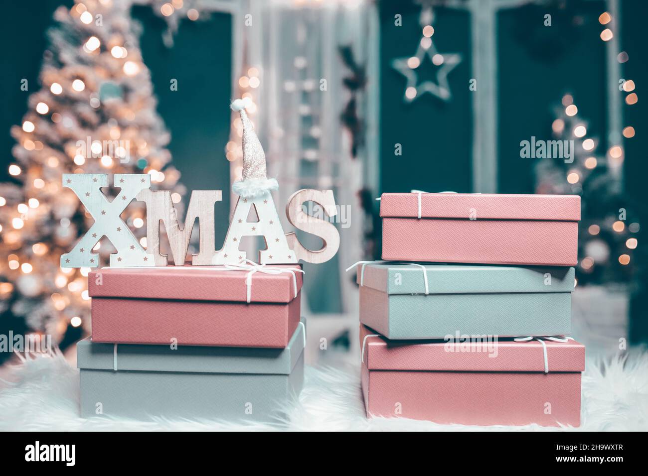 Pile of gift boxes near beautiful Christmas tree indoors Stock Photo ...
