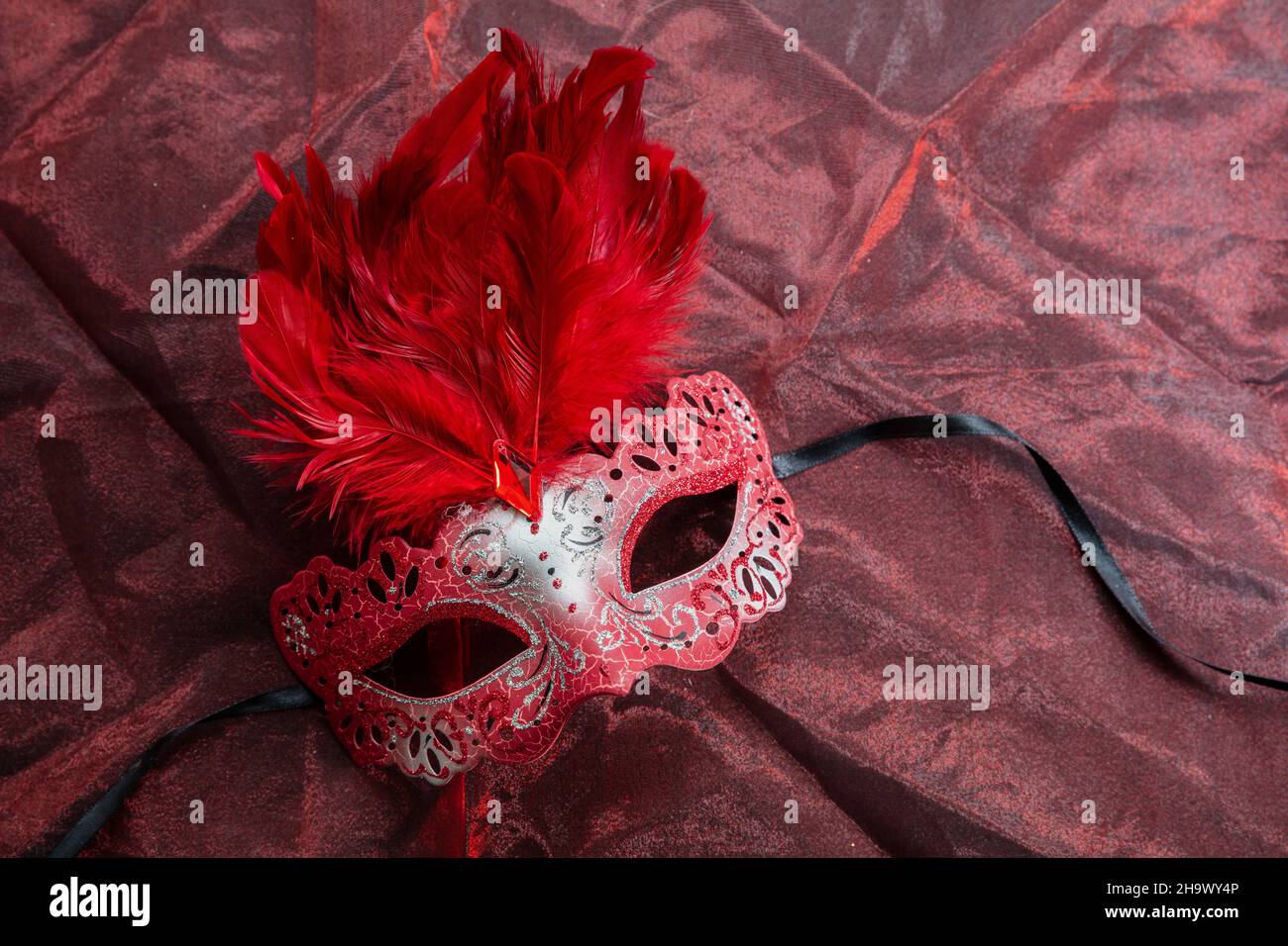 Carnival Venetian mask red color with glitter and feathers decoration ...