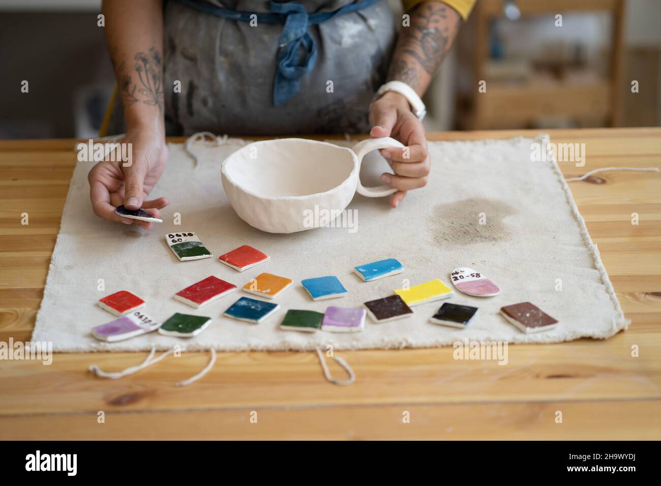 Ceramic painting. Woman ceramist choosing paint color, production ...