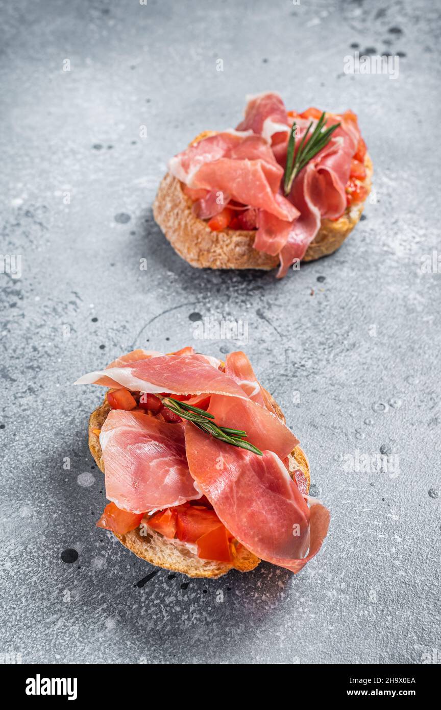 Spanish Tapas with tomatoes and cured Slices of jamon iberico ham ...