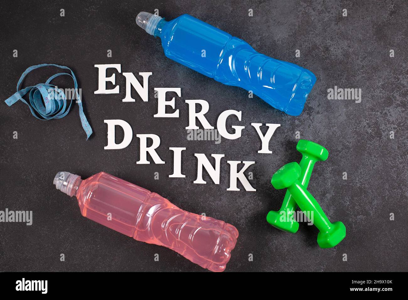 Words ENERGY DRINK and Bottles with different flavors and dumbbells on ...