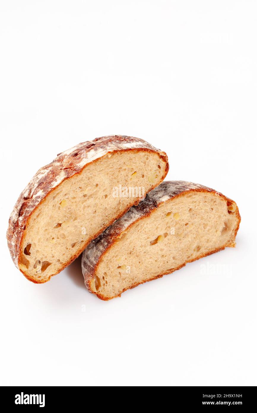 Round wheat bread with cheese inside cut in half on white background ...