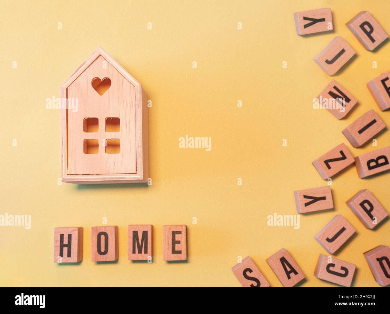 Word home, taken from a stack of wooden letter blocks and a wooden ...