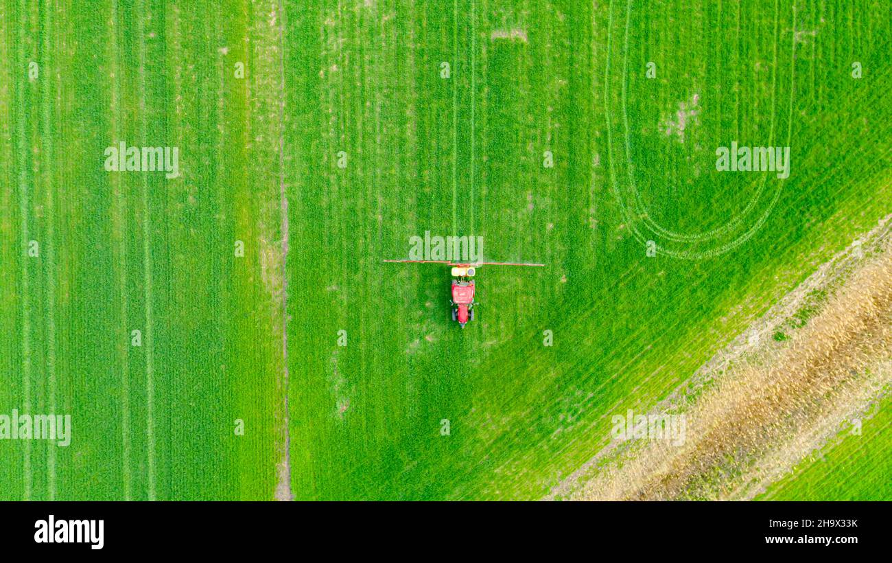 Above top view, overhead view on tractor as spraying farmland with ...