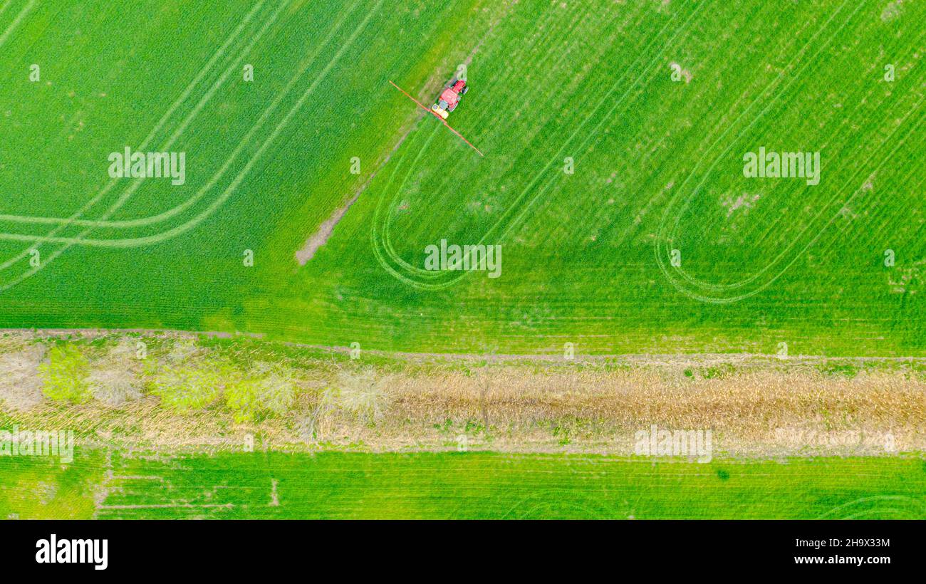 Above top view, overhead view on tractor as spraying farmland with ...