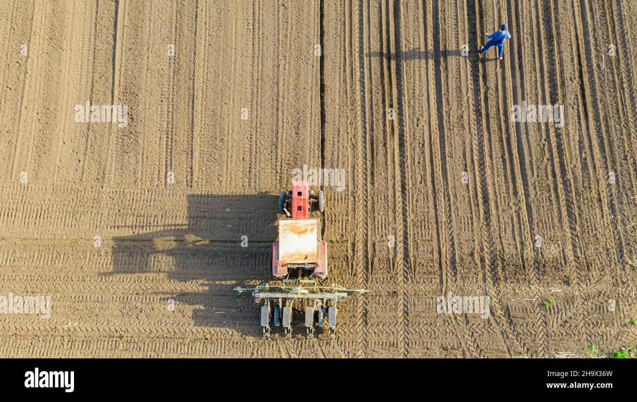 Above top view, shot of worker is check or adjust seed drill ...