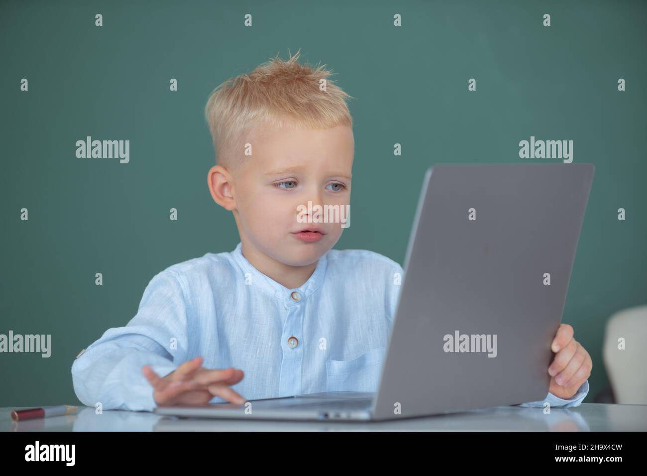Child using gadgets to study. Computer education for kids. Little funny ...