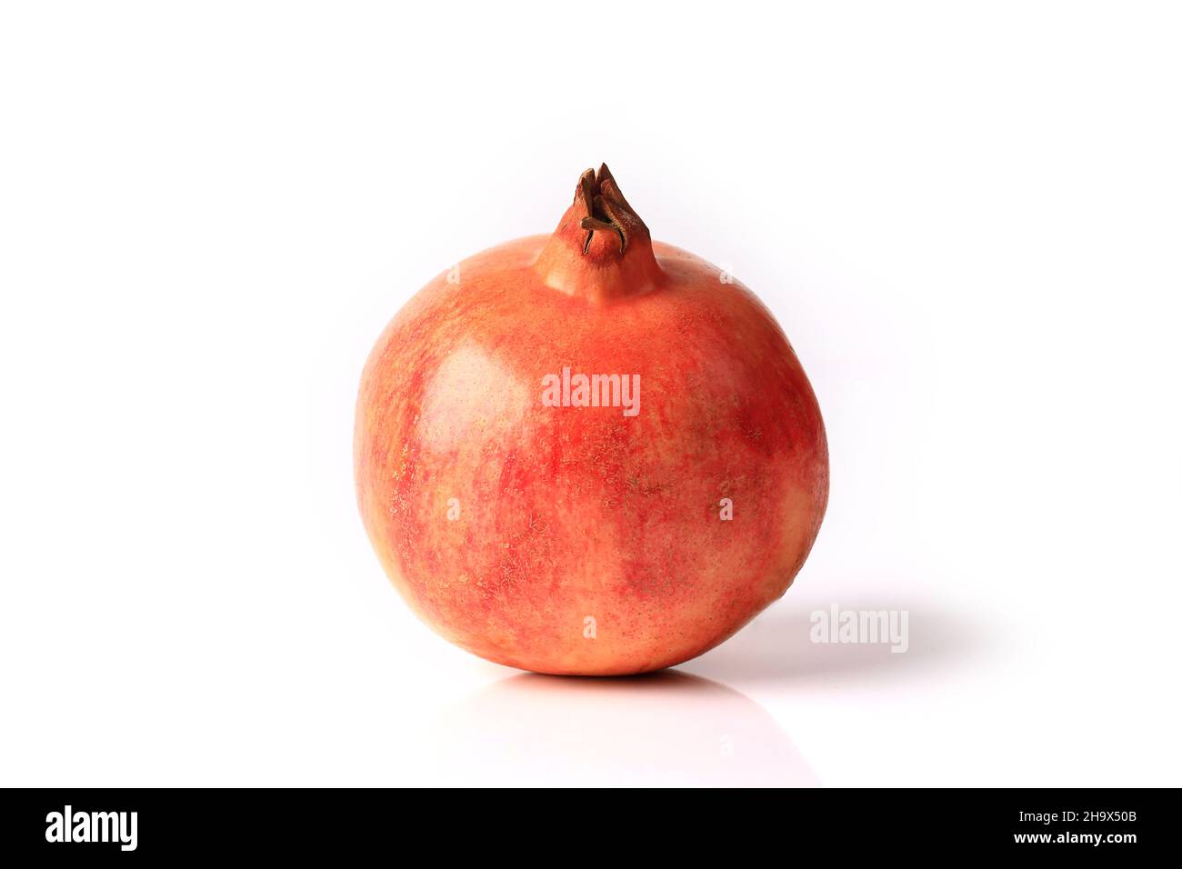 whole pomegranate isolated on white background Stock Photo - Alamy