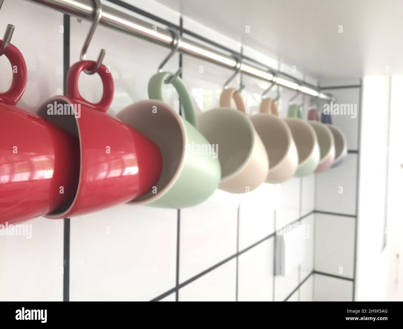 Hanging the coffee cups in row Stock Photo - Alamy