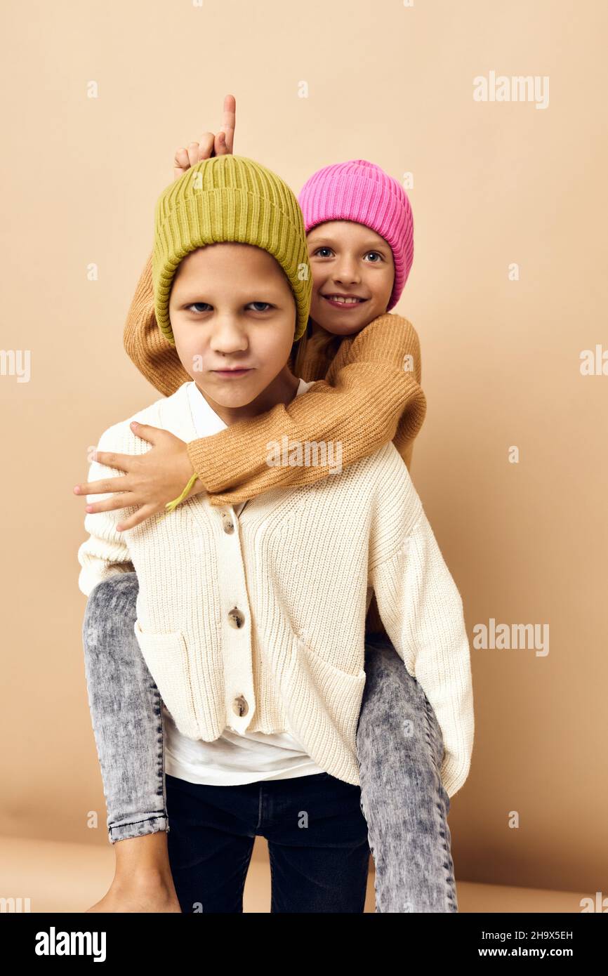 portrait of cute children hug games smile friendship beige background ...