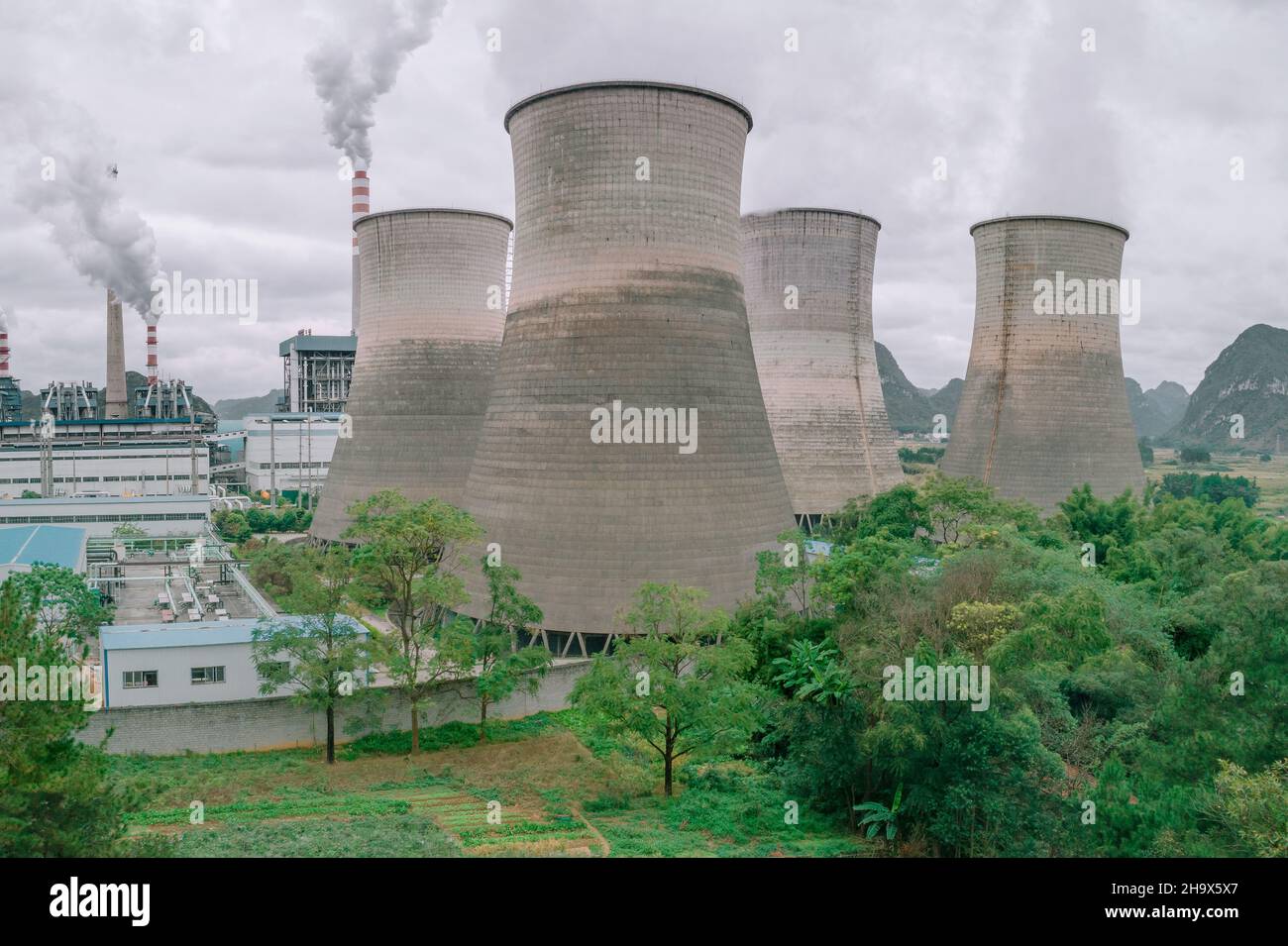 The cooling tower of the factory built next to the green space Stock ...