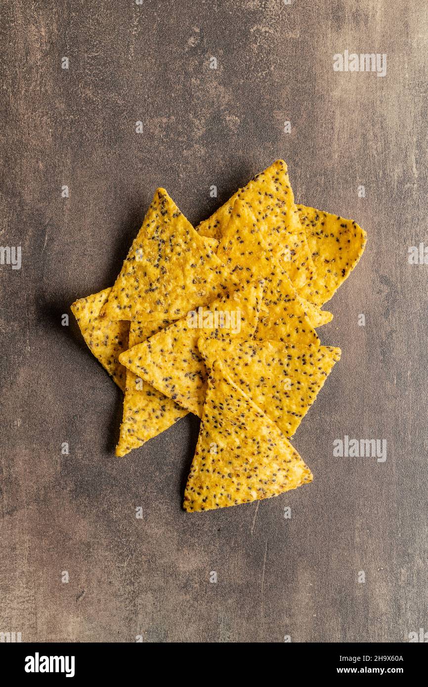 Salted tortilla chips triangle with chia seeds. Top view Stock Photo ...