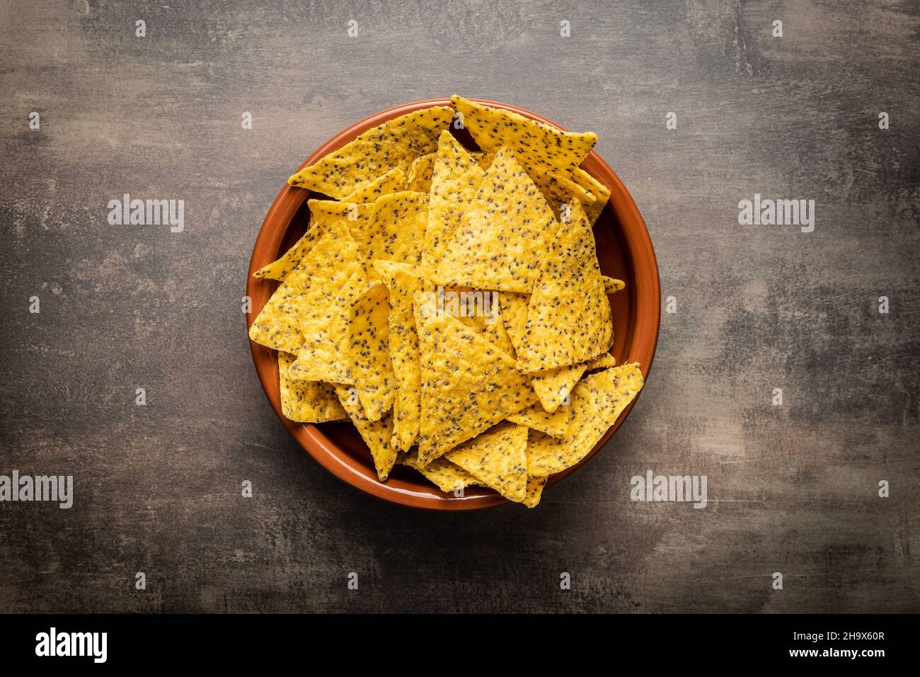 Salted tortilla chips triangle with chia seeds in bowl. Top view Stock ...