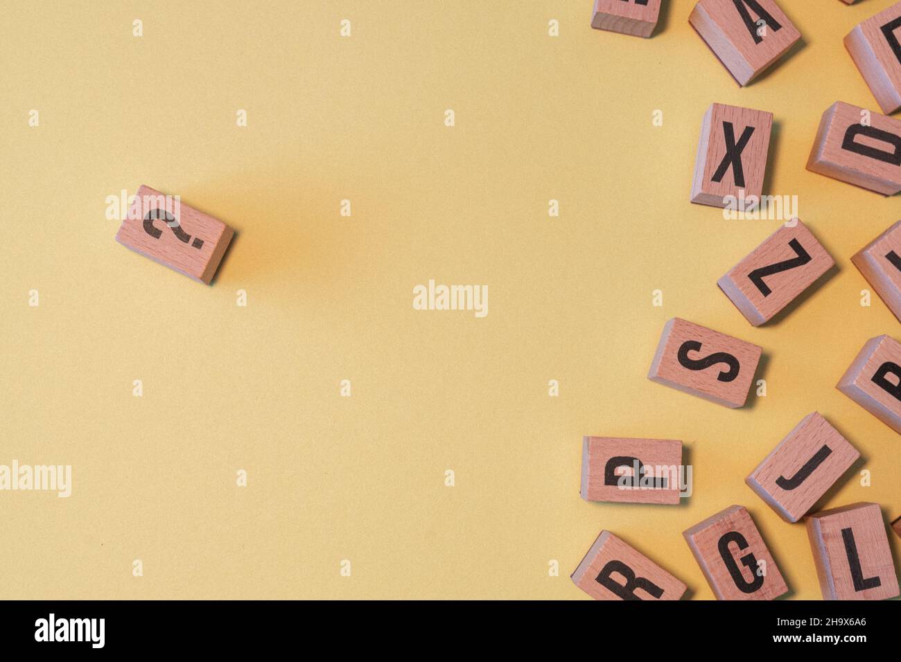 Question mark, taken from a pile of wooden letter blocks in the yellow ...