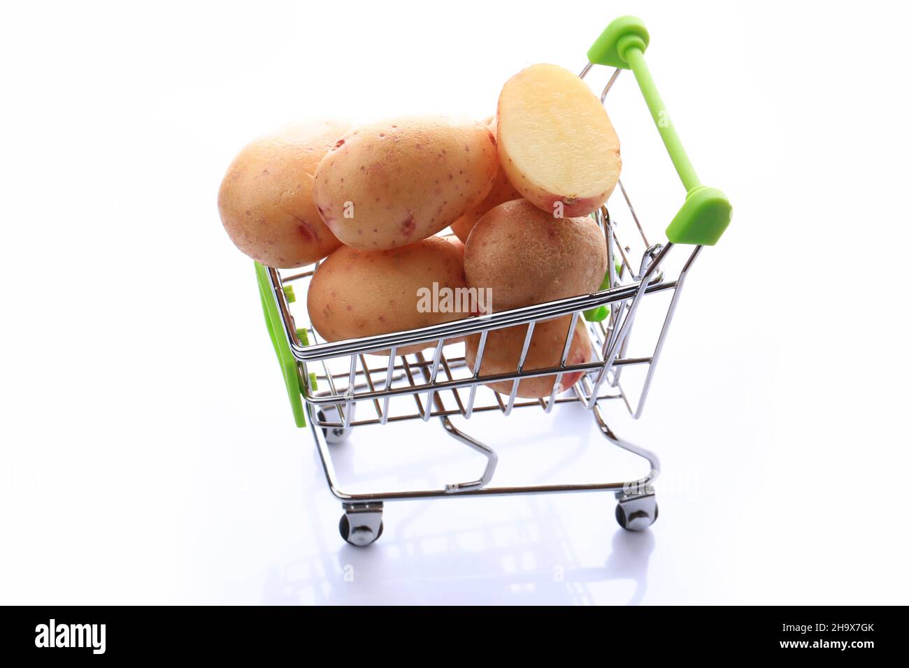 raw potatoes in a shopping cart isolated on white background Stock ...