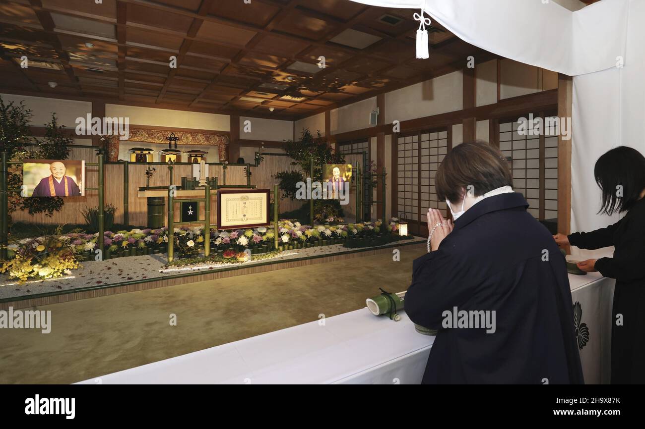 People pray on Dec. 9, 2021, at an altar set up at the home of the late ...