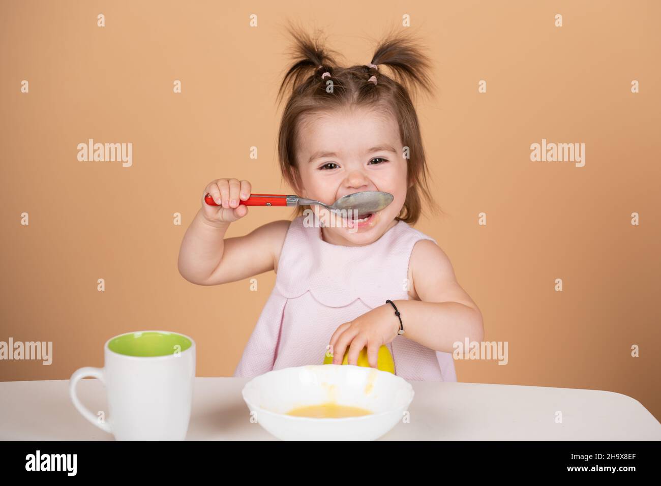 Kid eat healthy nutrition, baby food. Babies eating with spoon. Little ...