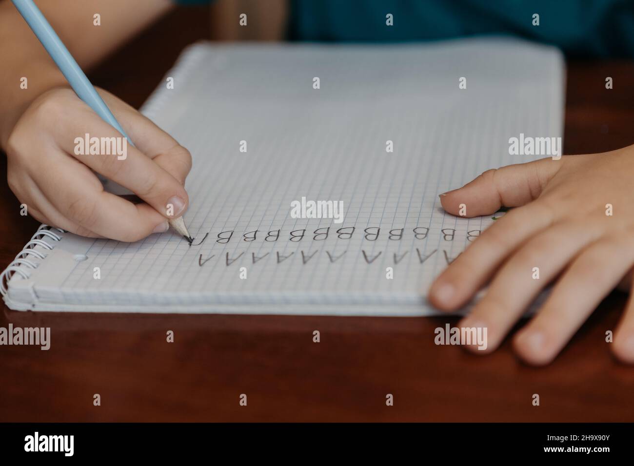 Close up of child writing letters in notebook Stock Photo - Alamy