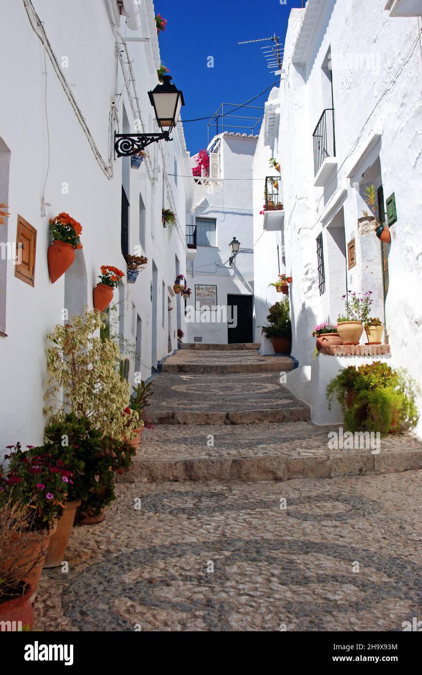 View along a steep stepped village street in the old town, Frigiliana ...