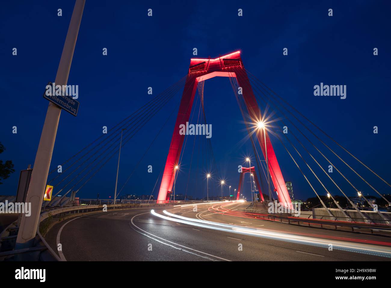 illuminated red pylons and deck of Willems Bridge across the Nieuwe ...