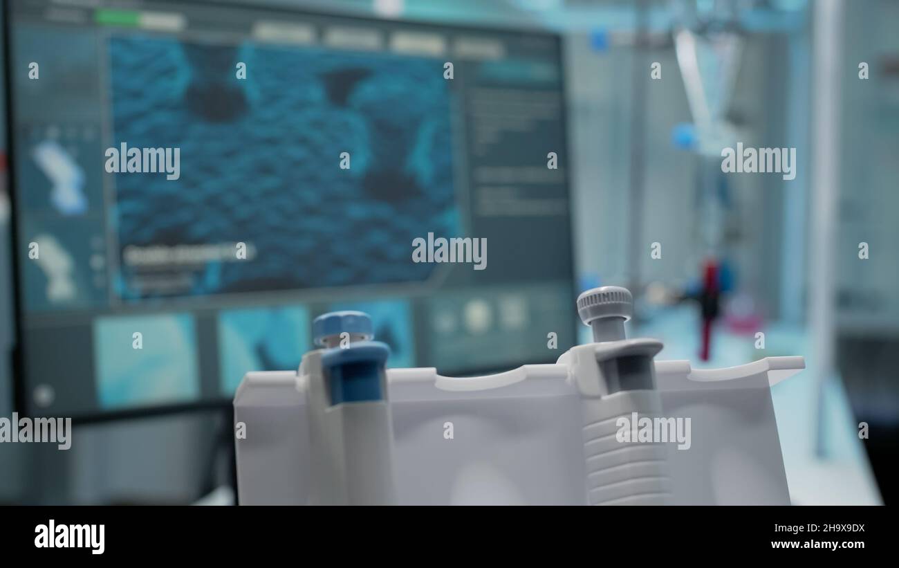 Close up of dna animation on computer and micropipette in scientific ...