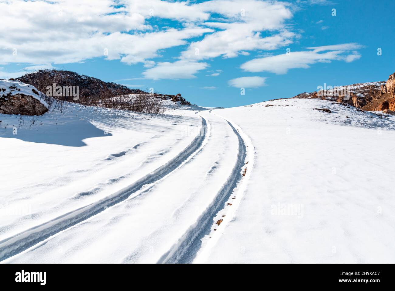 Car track on snow in highlands Stock Photo - Alamy