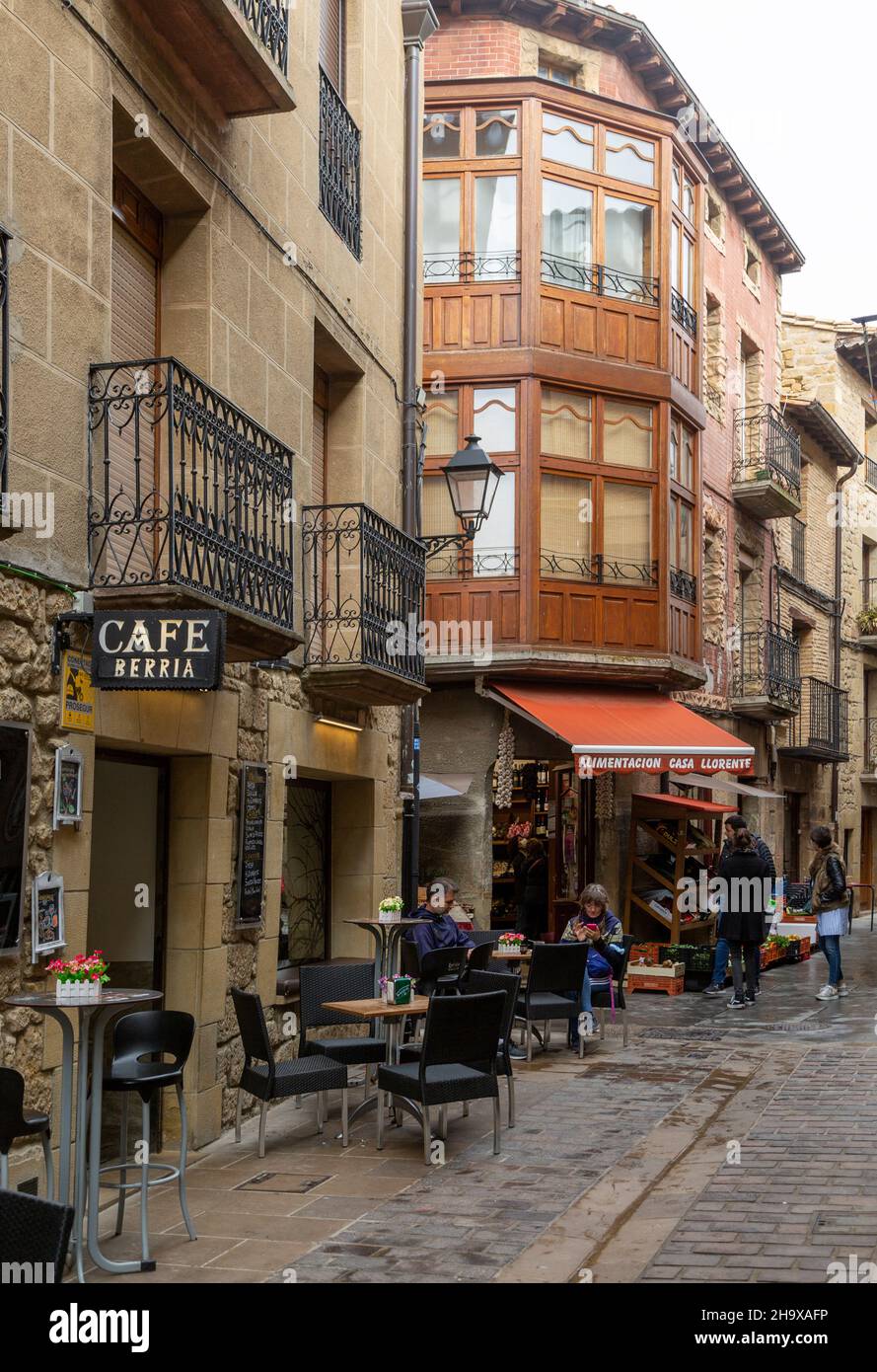 People in street on a wet day in village of Laguardia, Álava, Basque ...