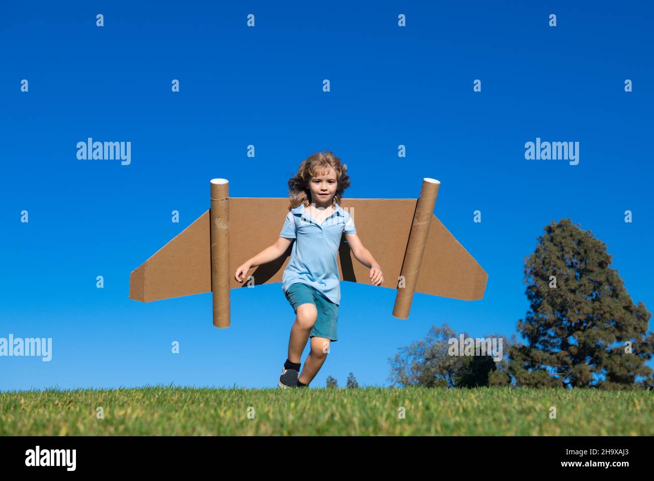 Kid with jet pack superhero. Child pilot against summer sky background ...