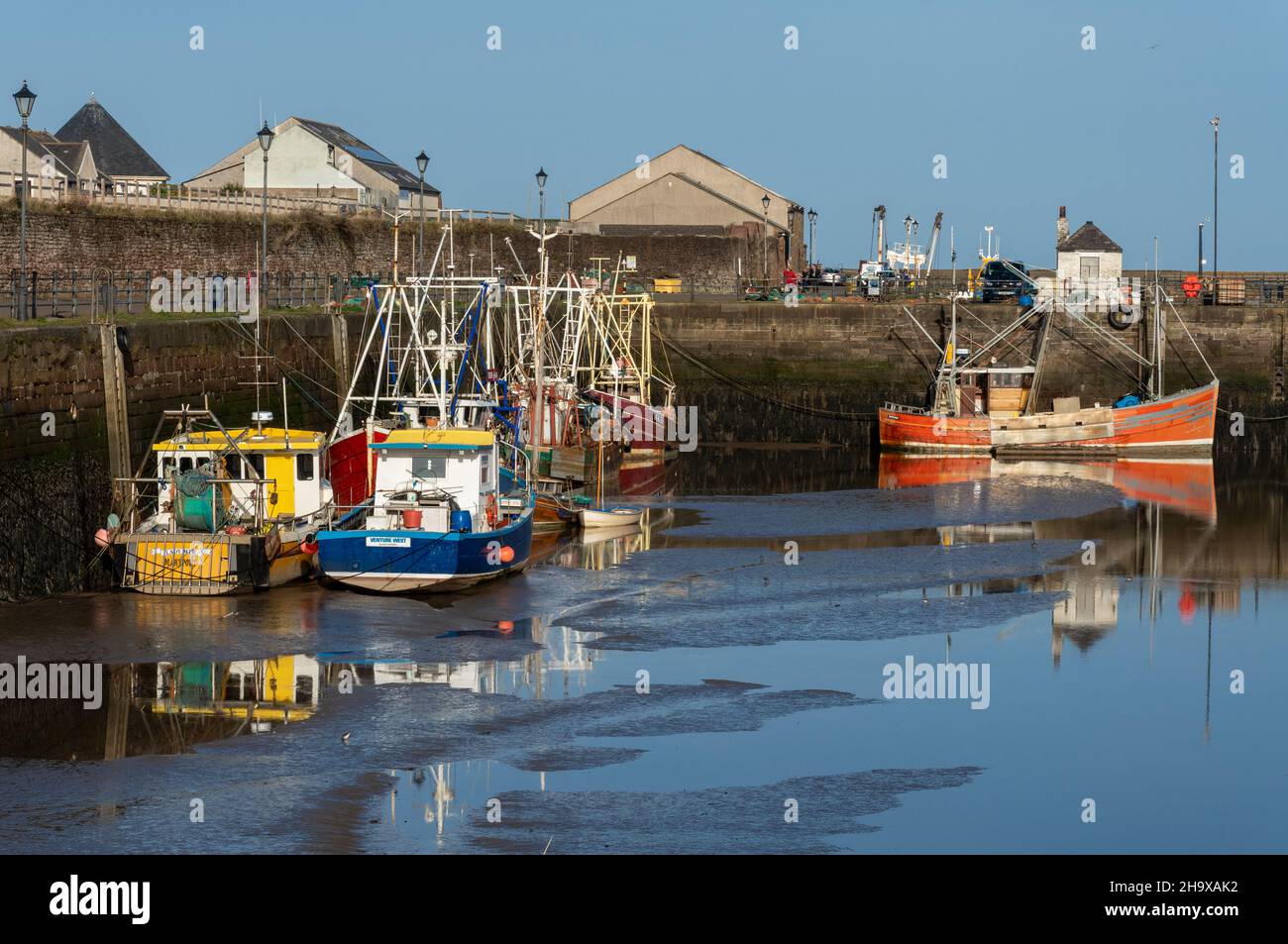 Colourful fishing boats in the harbour at Maryport, a pretty coastal ...