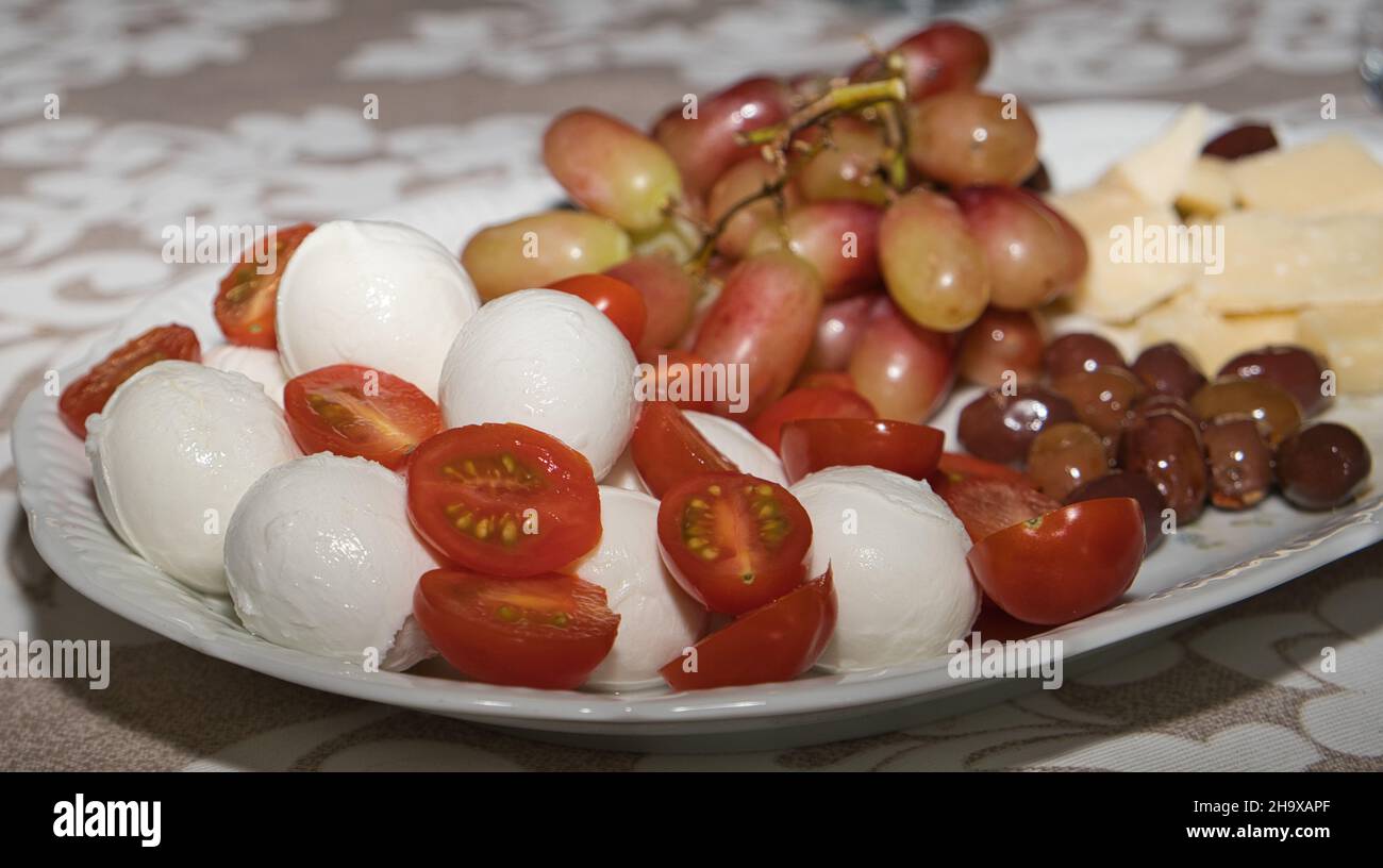 Typical Mediterranean starter with buffalo mozzarella, tomato, olives ...