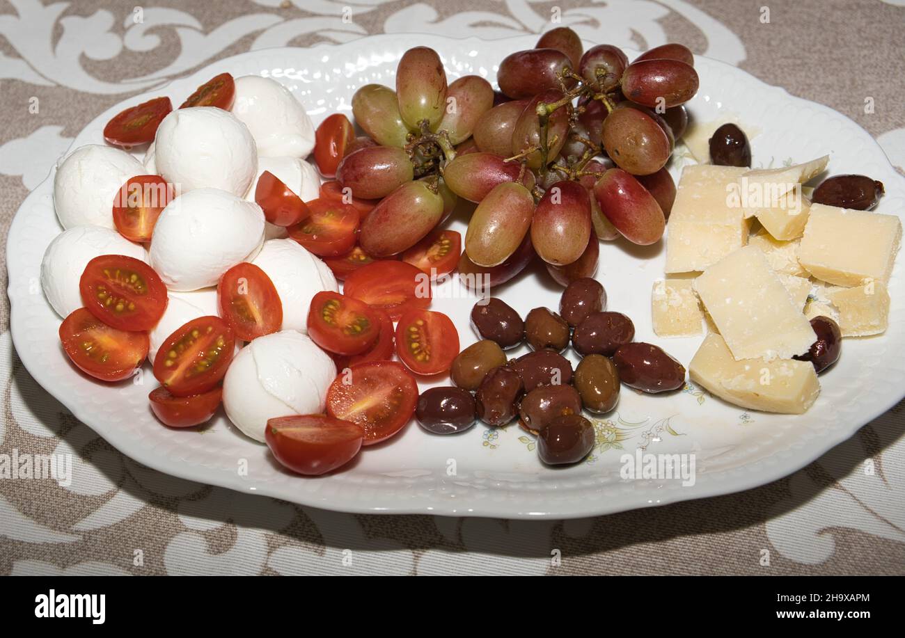 Typical Mediterranean starter with buffalo mozzarella, tomato, olives ...