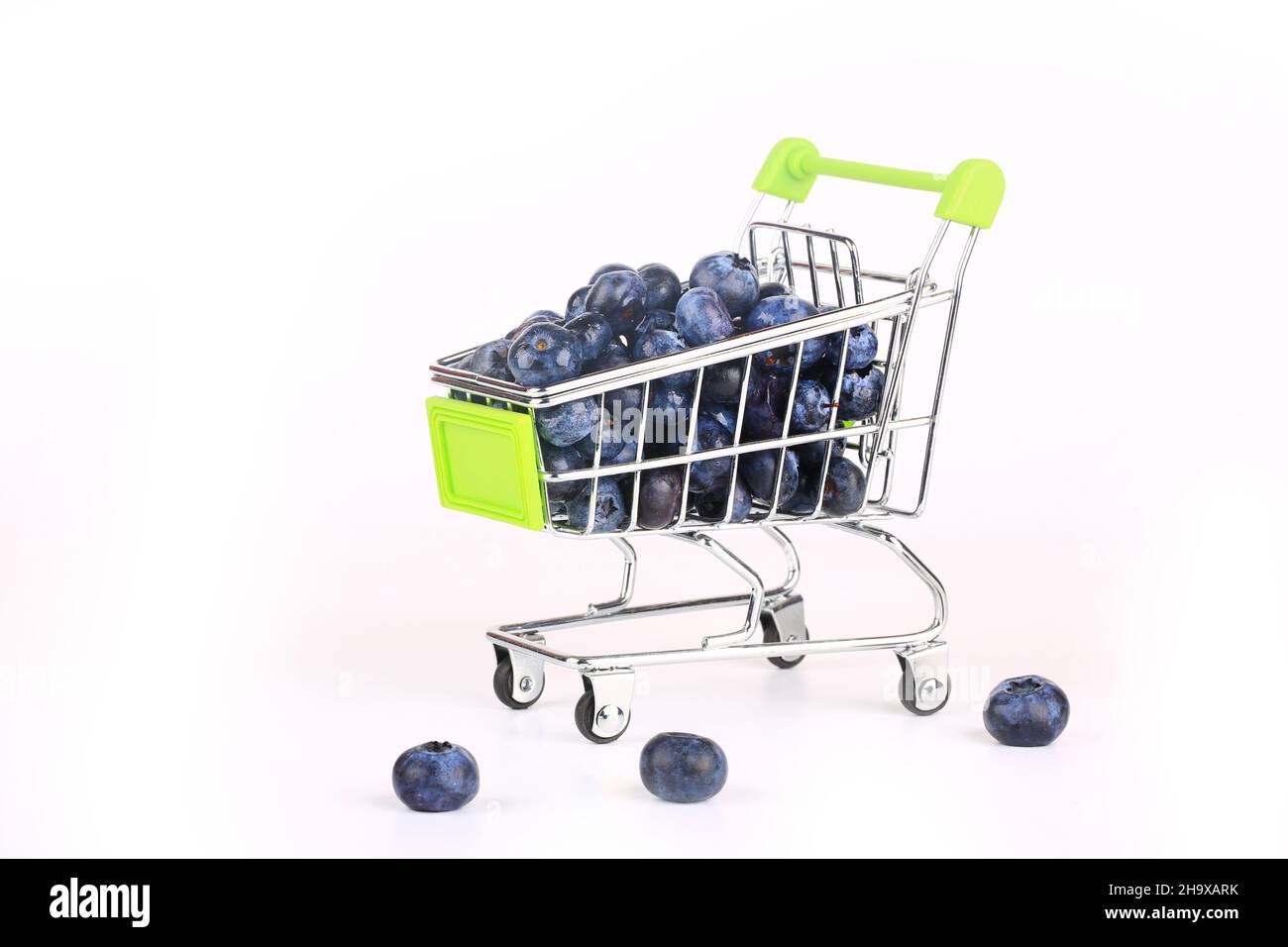 Blueberry berries in a shopping trolley isolated on white background ...