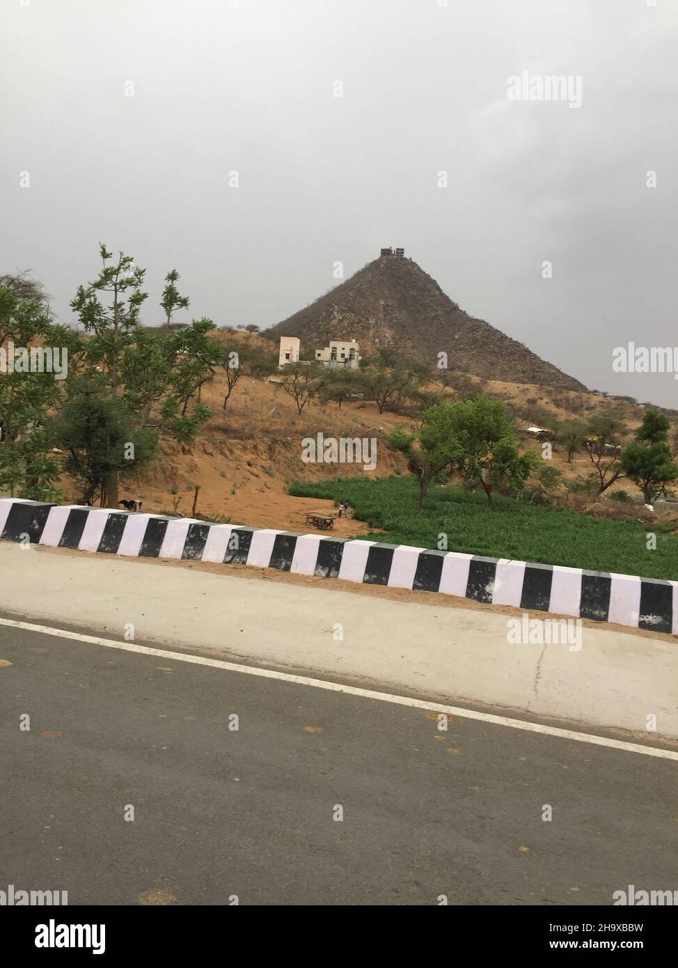 Small hill from a distance on the roadside Stock Photo - Alamy