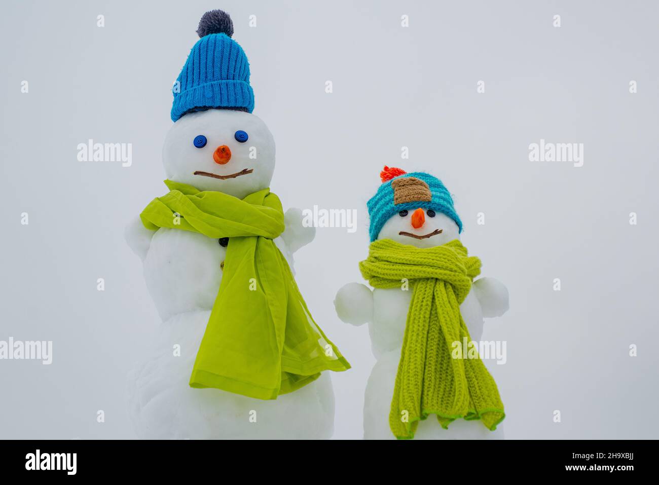 Snow man. Two snowman on snowy background Stock Photo - Alamy